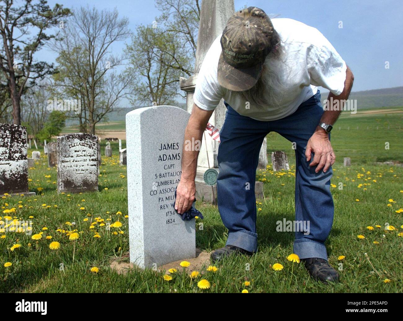 ** ADVANCE FOR WEEKEND, MAY 28-30 **Local historian Forest Kauffman wipes the new headstone at ...