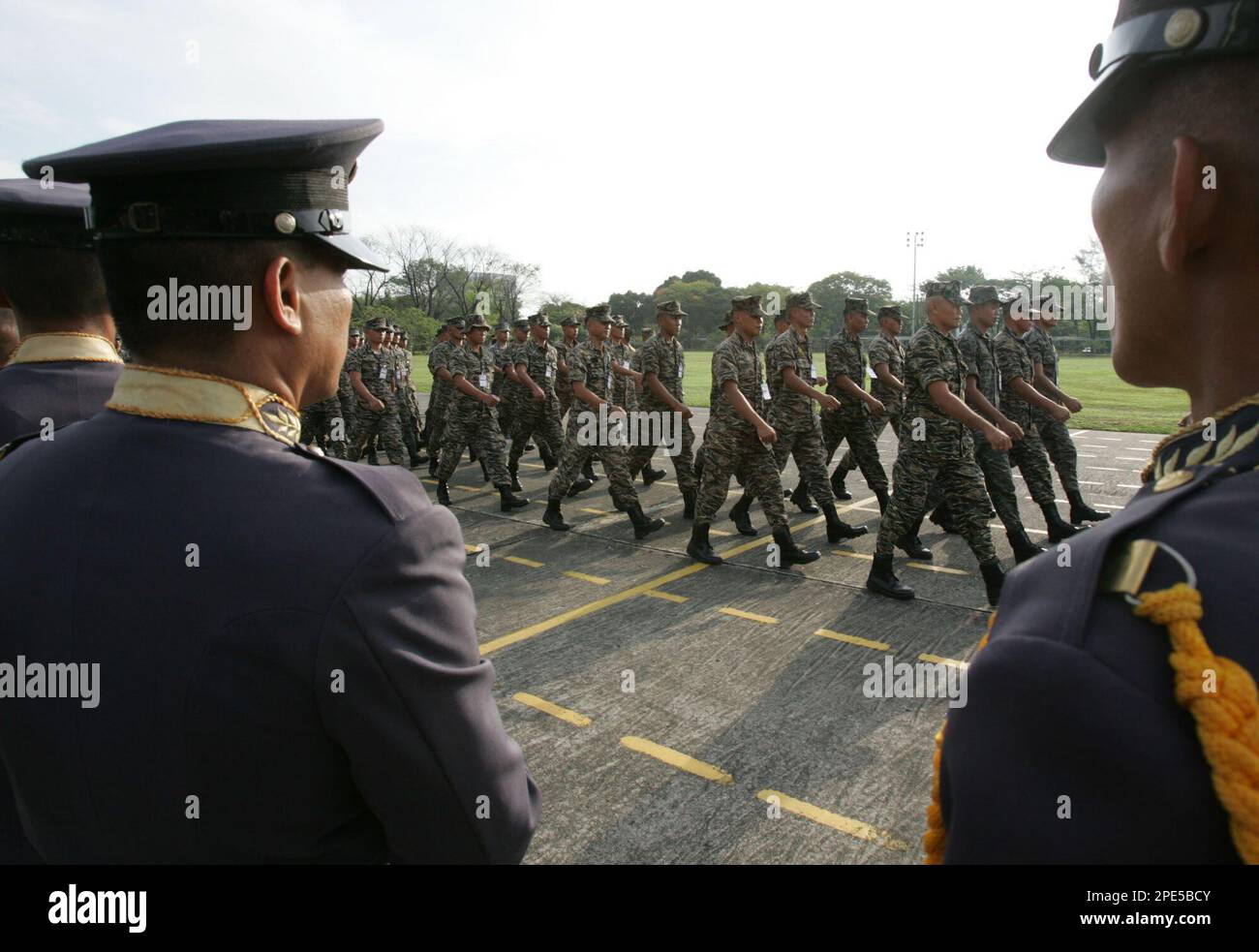 Filipino honor guards watch as soldiers who took part in the failed ...