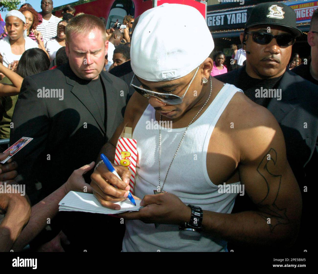 St. Louis rapper Nelly signs autographs for fans before the charity ...
