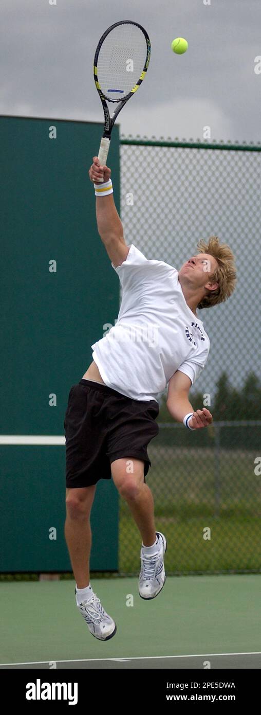 Polson junior Andy Dykstra serves against Polson's Brian Dubuque during ...