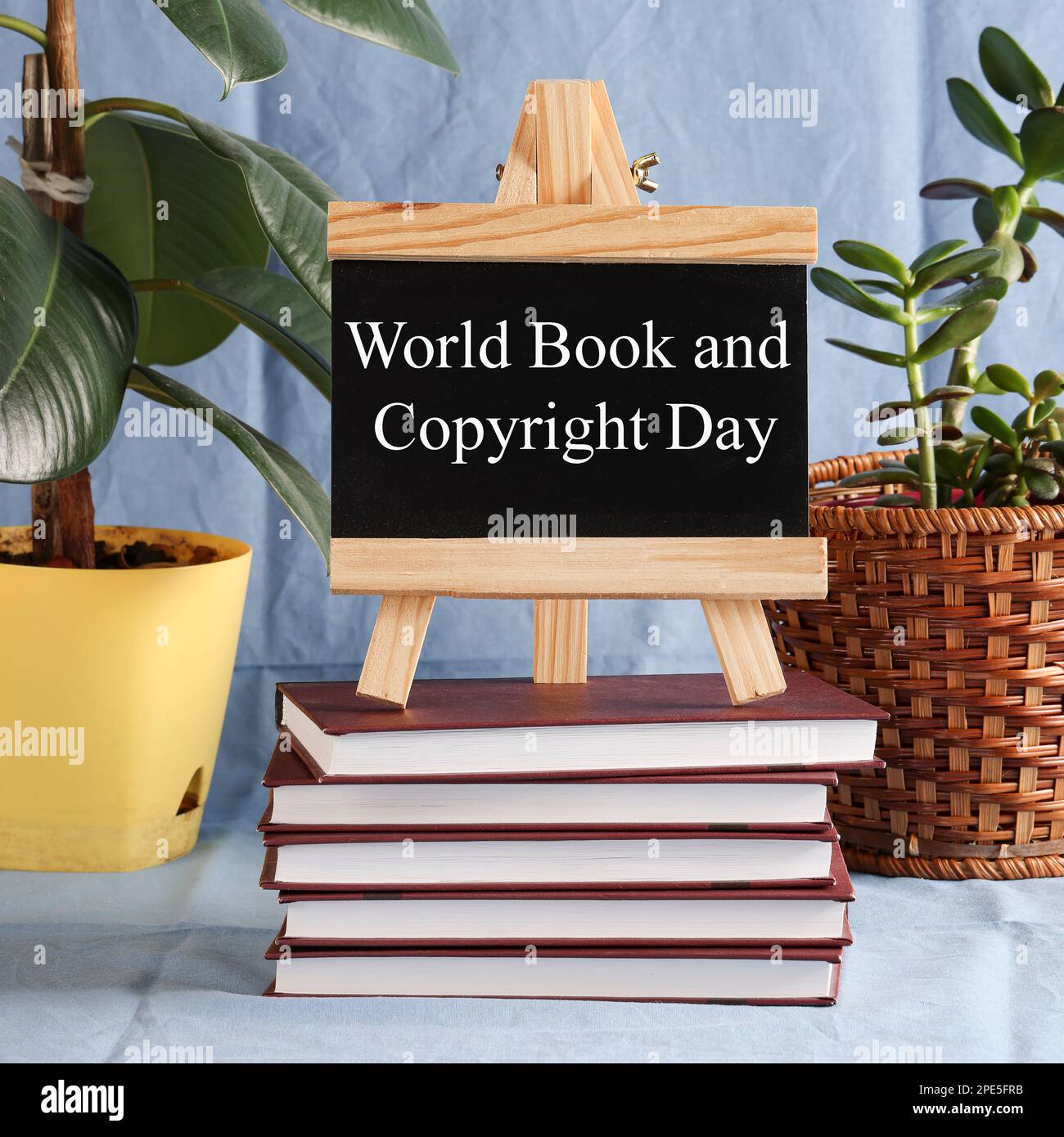 World Book and Copyright Day written on black board on stack of books ...