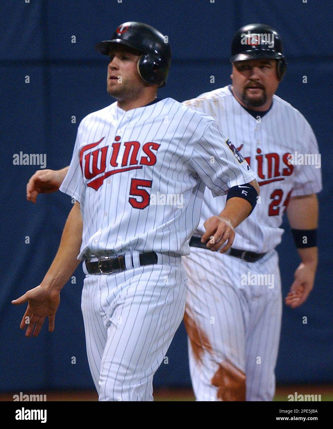 Minnesota Twins' Michael Cuddyer, left, is congratulated by Matthew ...