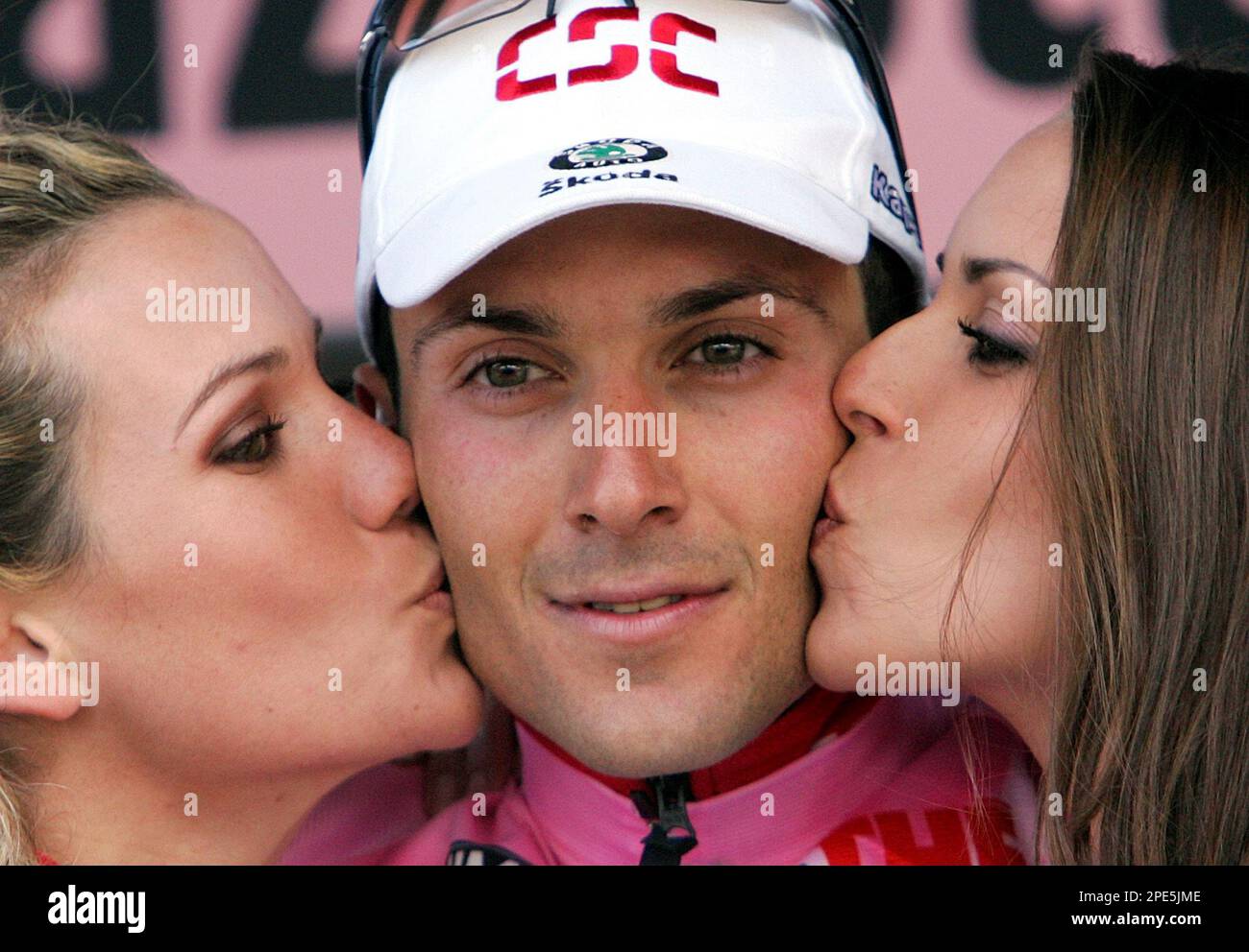 Italy's Ivan Basso receives the traditional kiss from race hostess ...