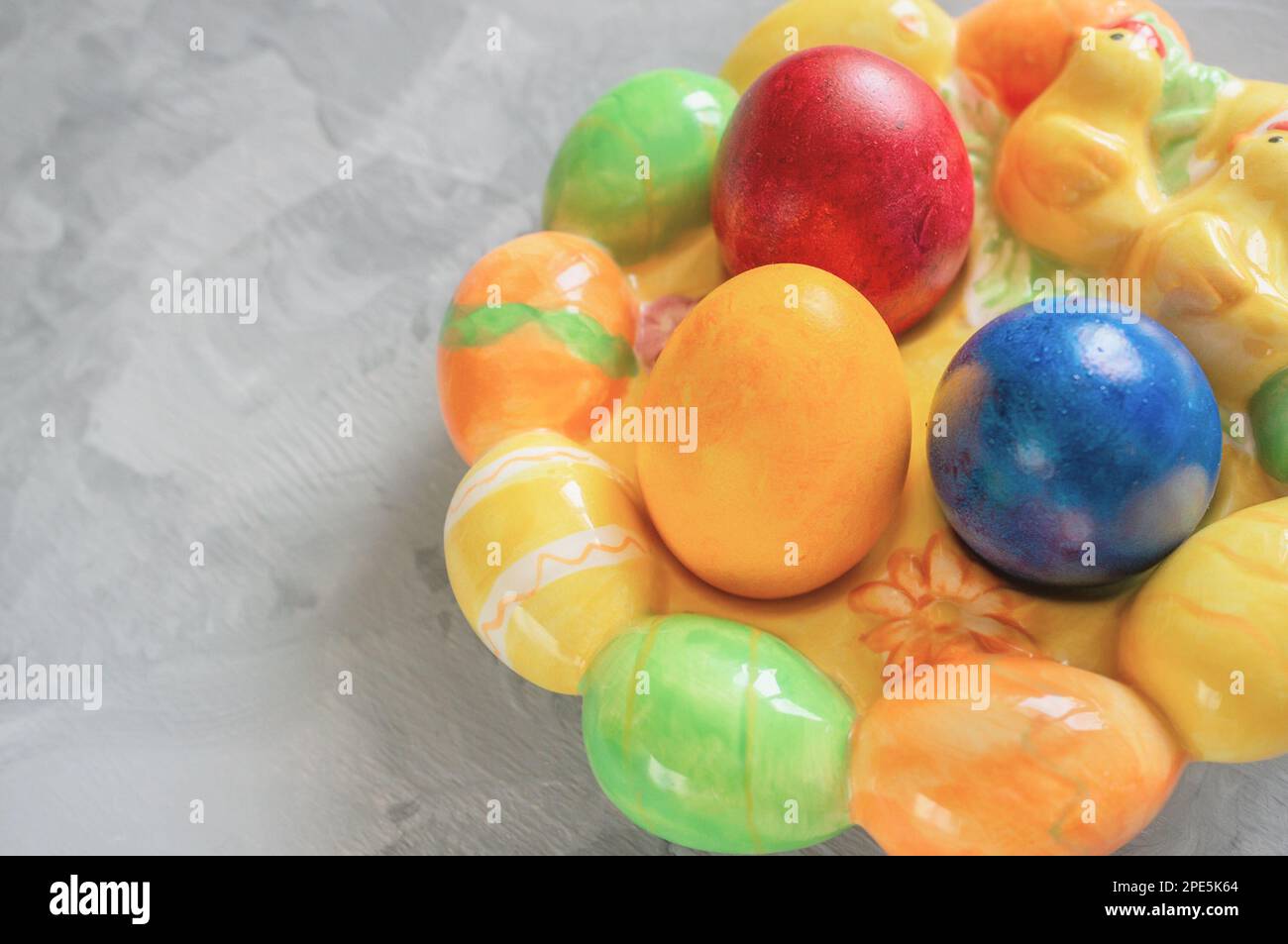 easter bright colored eggs in an Easter egg stand. Festive Easter ...