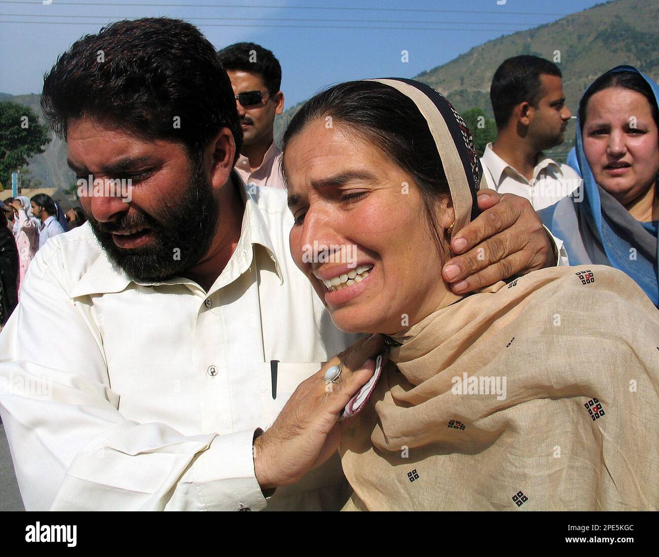 Indian Kashmiri woman Shameem Akhtar, right, is comforted by her cousin ...