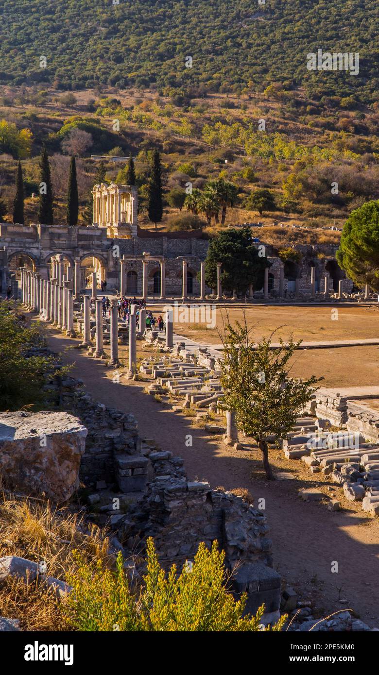 A group of tourists exploring ruins of the Ancient City of Ephesus ...