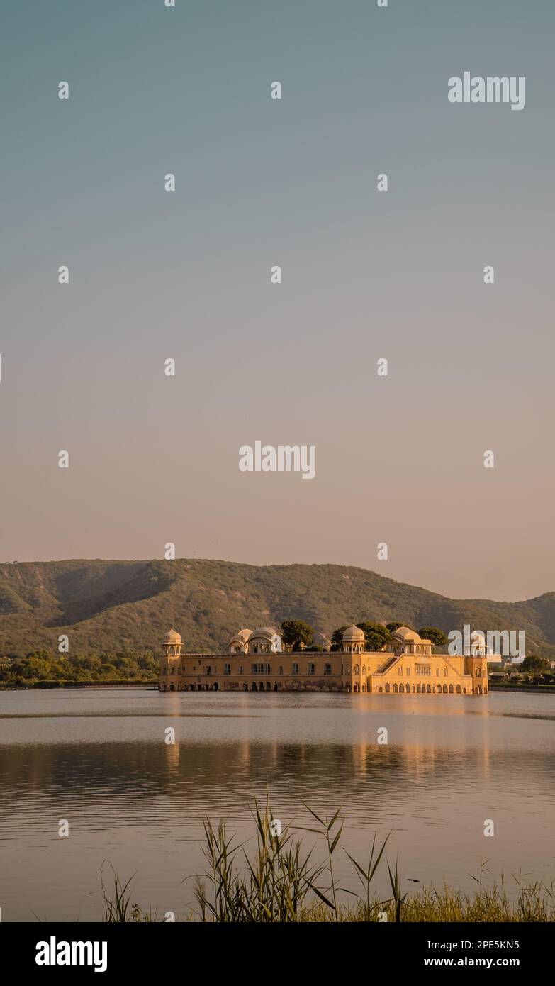 A vertical shot of Jal Mahal palace in the middle of the Man Sagar Lake ...