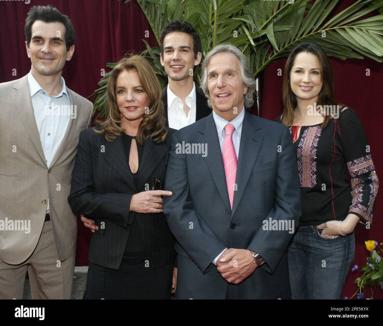 The cast of "Out of Practice," poses for photographers after arriving ...