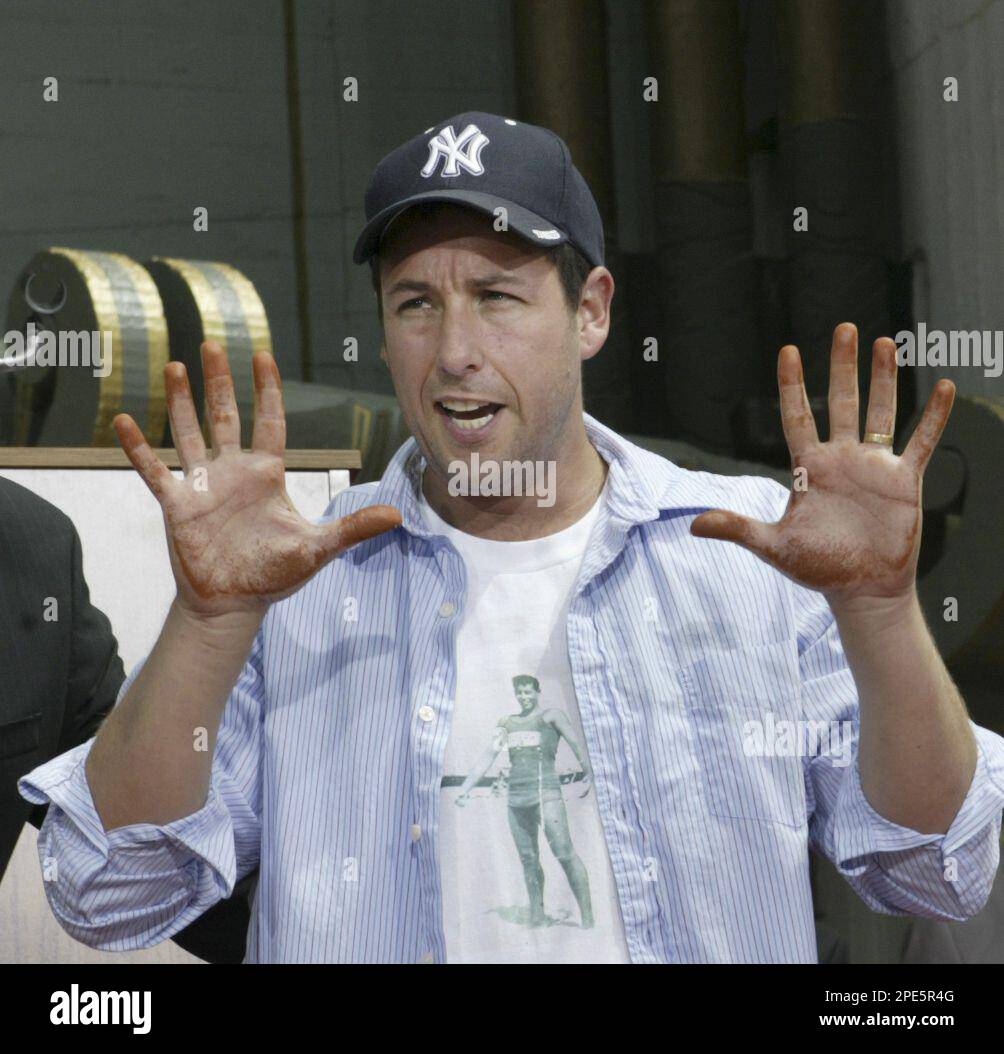 Actor/comedian Adam Sandler, star of "The Longest Yard," holds his ...