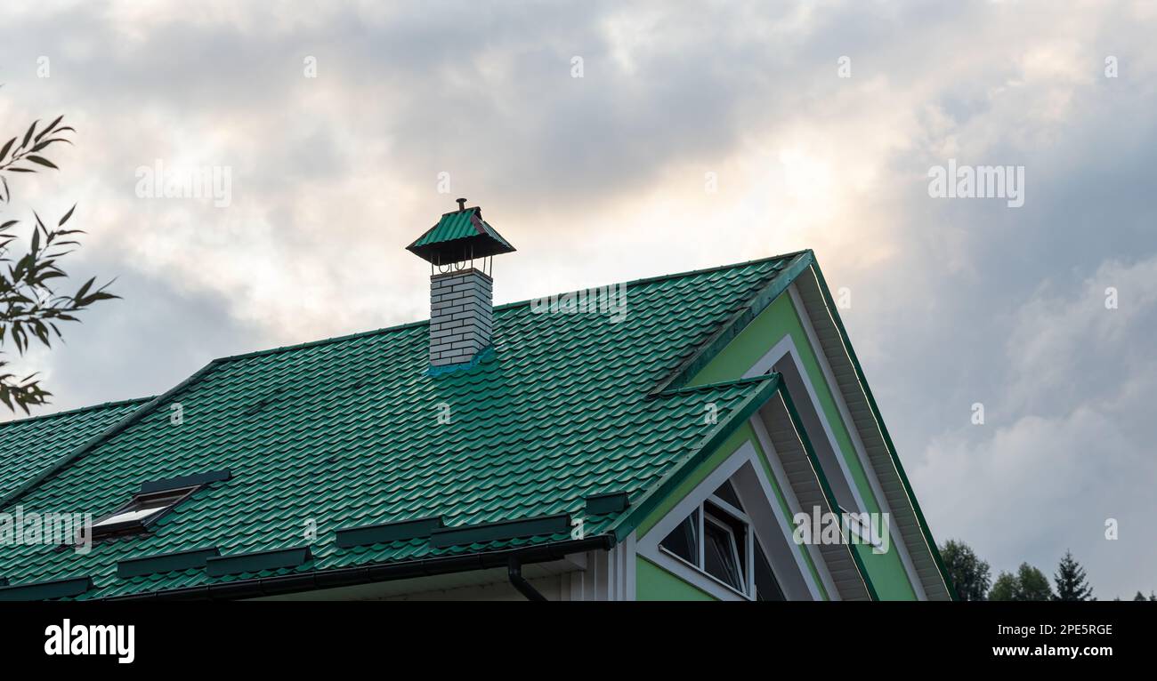 roof covered with metal tiles, roofing, wooden house Stock Photo - Alamy