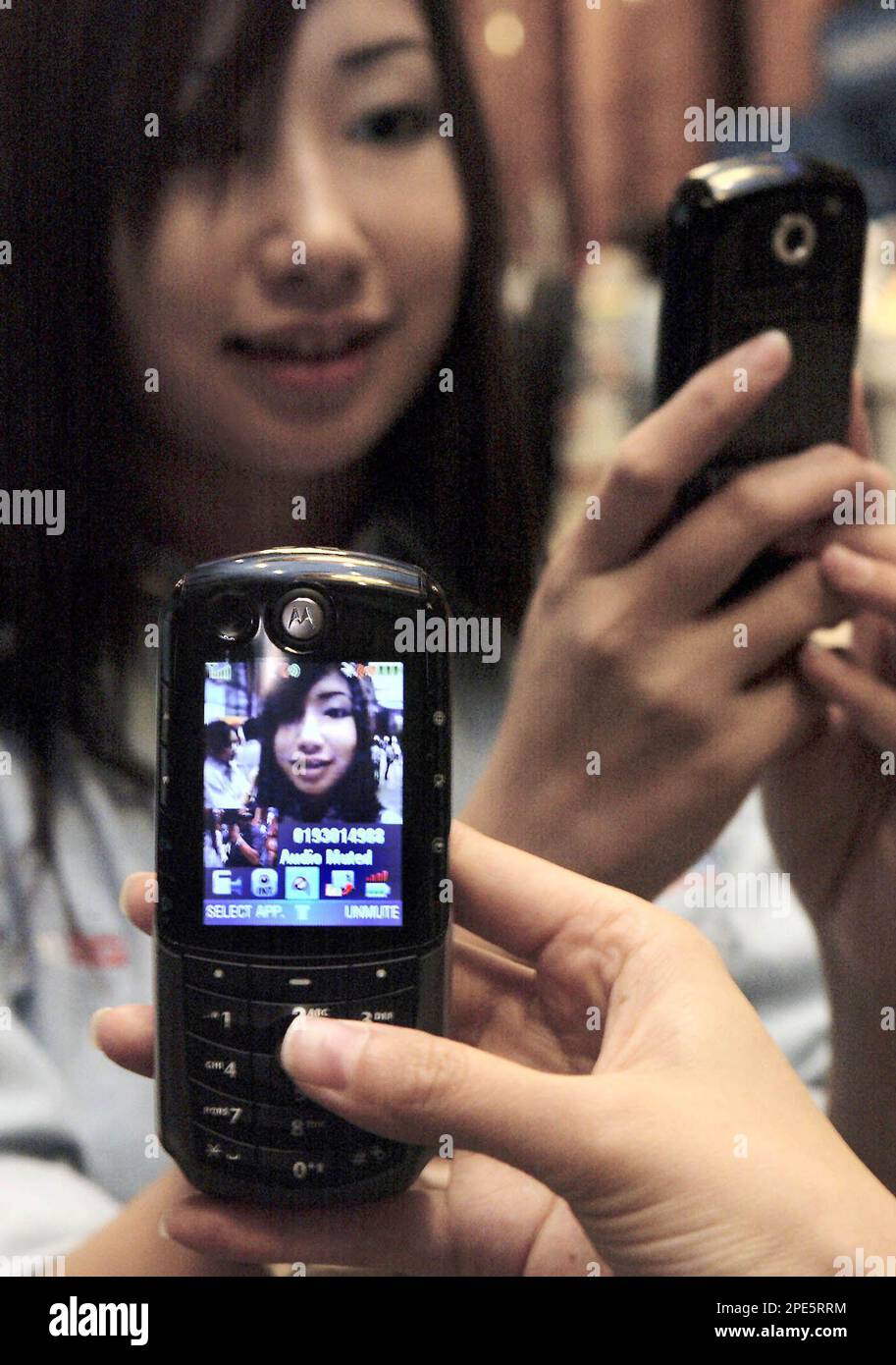 A Celcom staff tries out the 3G mobile services through the Motorola ...