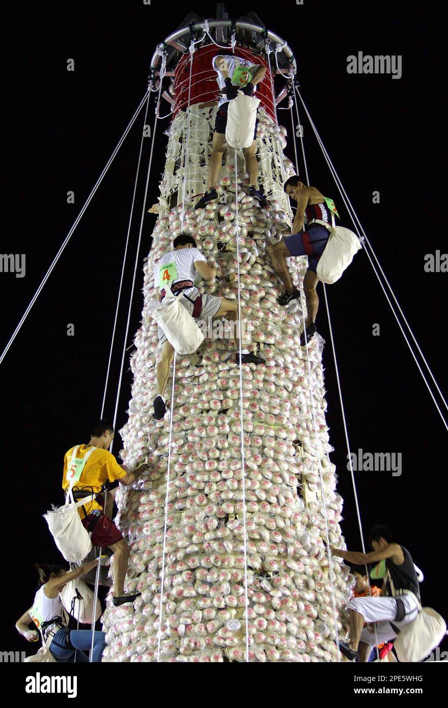 Bun-snatchers climb over a 14 meter-tall (46 feet) bun tower to grab as ...