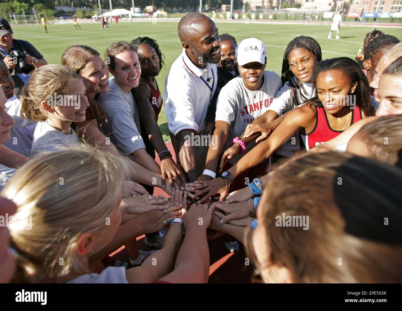 Members of Stanford's women's track and field team join hands with ...