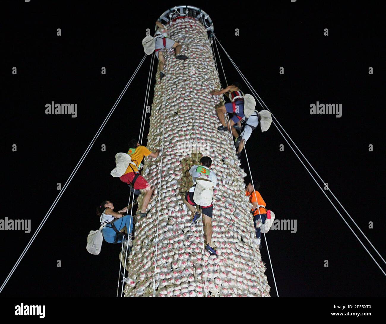 Bun-snatchers climb over a14 meter-tall (46 feet) bun tower to grab as ...