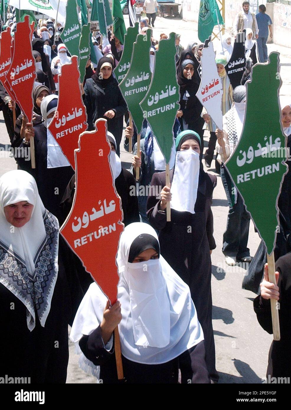 Women belonging to the Hamas militant group carry cutouts in the shape ...