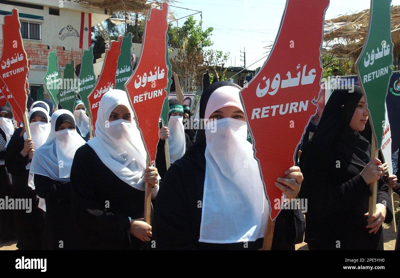 Women belonging to the Hamas militant group carry cutouts in the shape ...