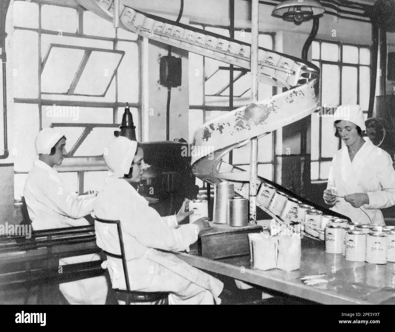 Packing dried milk, c1933. Women packing canned dried milk in a factory ...