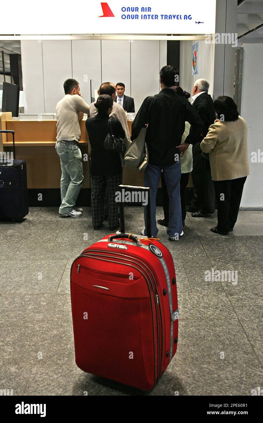 Turkish travellers try to get some information at the check in counter ...