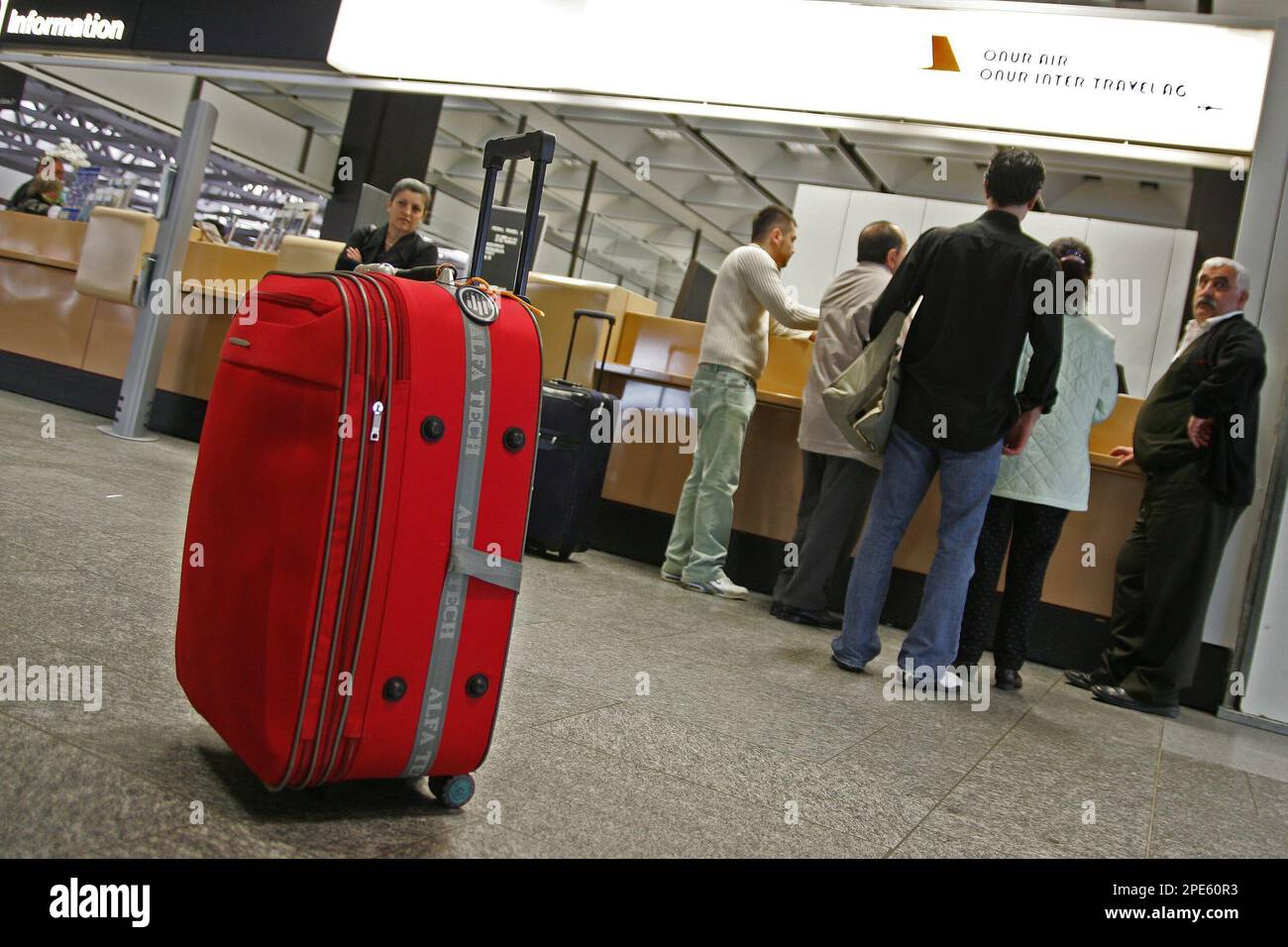 Turkish travellers try to get some information at the check in counter ...