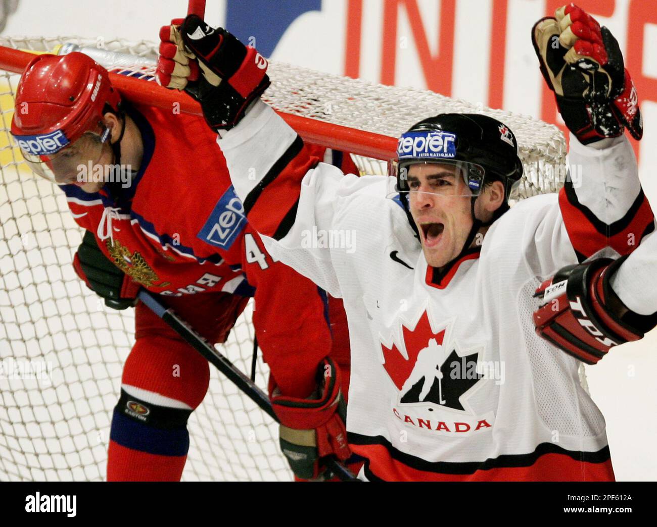 Team Canada's Wade Redden, right, celebrates after he scored his team's ...
