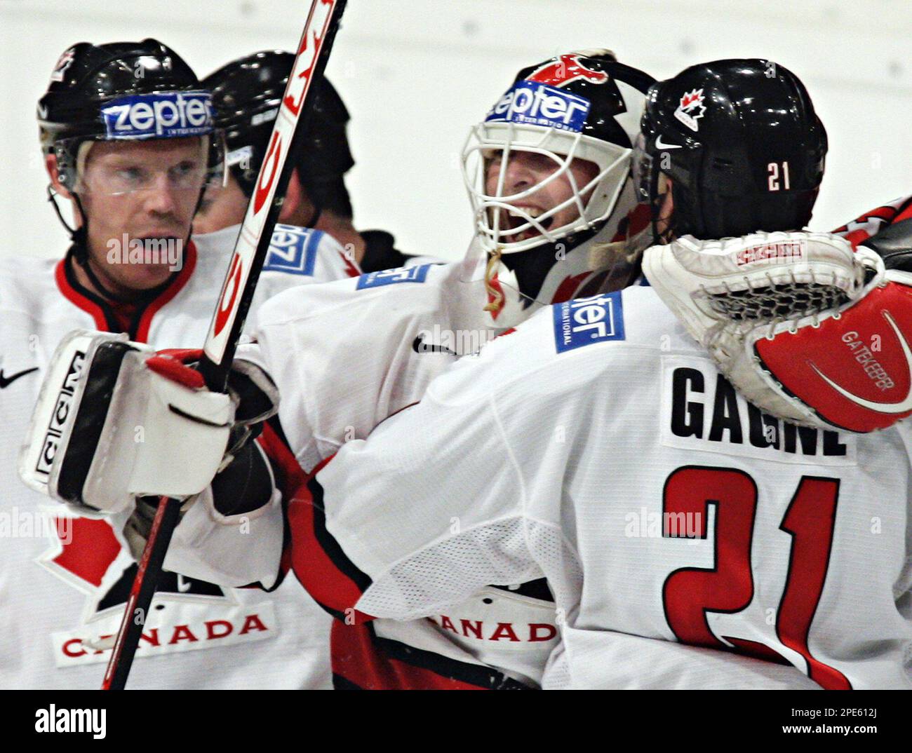 Team Canada goaltender Martin Brodeur, center, aises his arms to ...