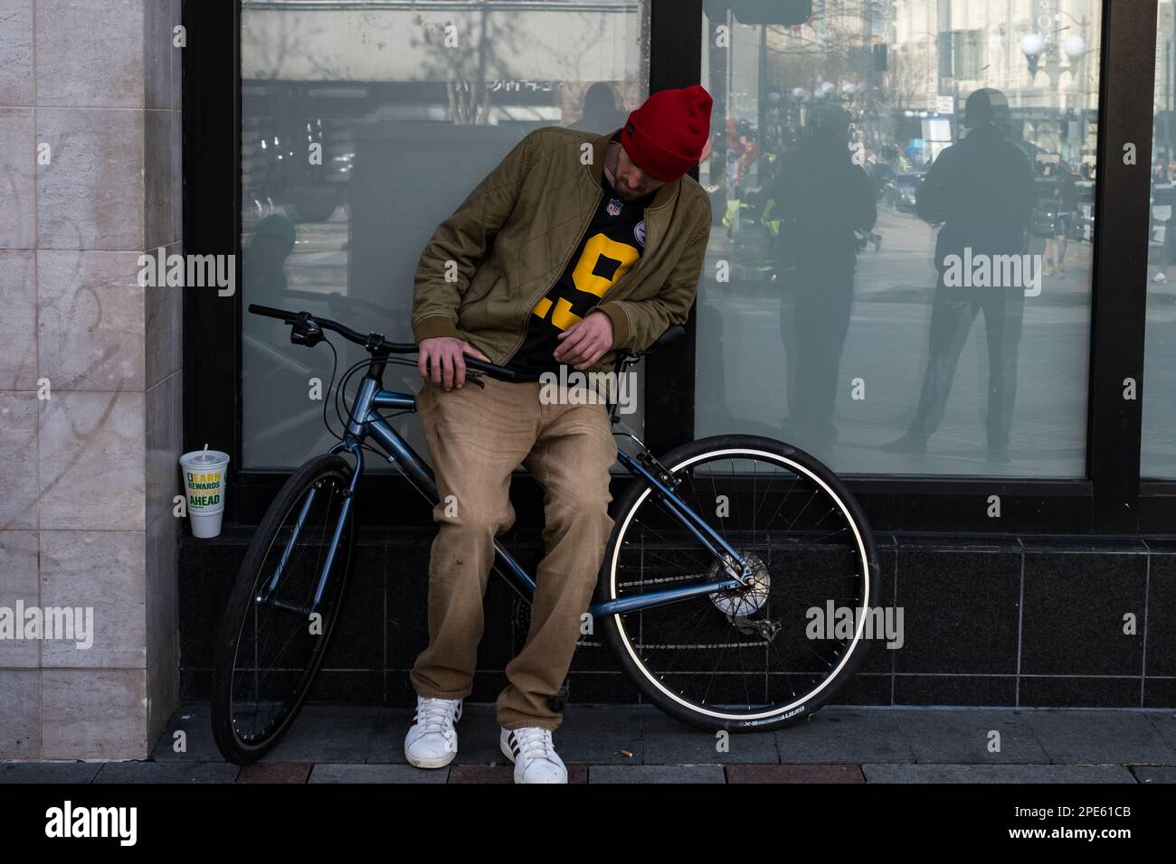 Seattle, USA. 11 Mar, 2023. A person sleeping on a bike at Westlake ...