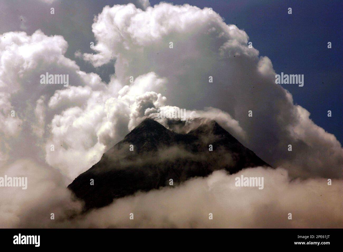 A white cloud of ash continues to spew from the mouth of Mount Mayon volcano in Albay province ...
