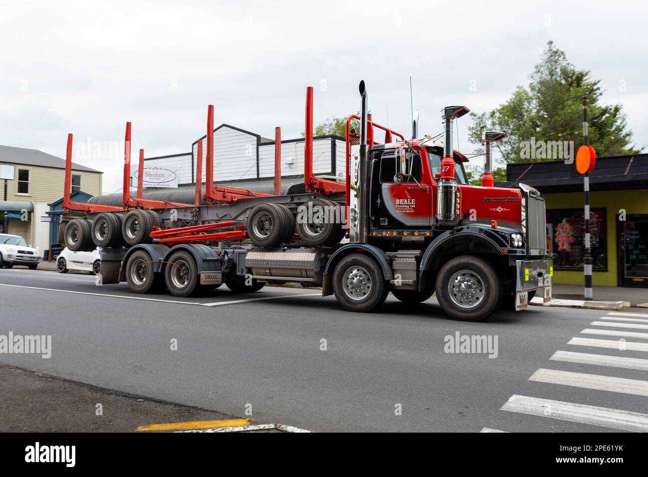 Logging lorry carrying empty trailer through Main Street, Greytown, New Zealand. Historic early ...