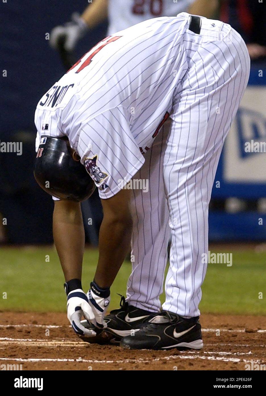 Minnesota Twins' Jacque Jones folds in half after being hit by a pitch ...