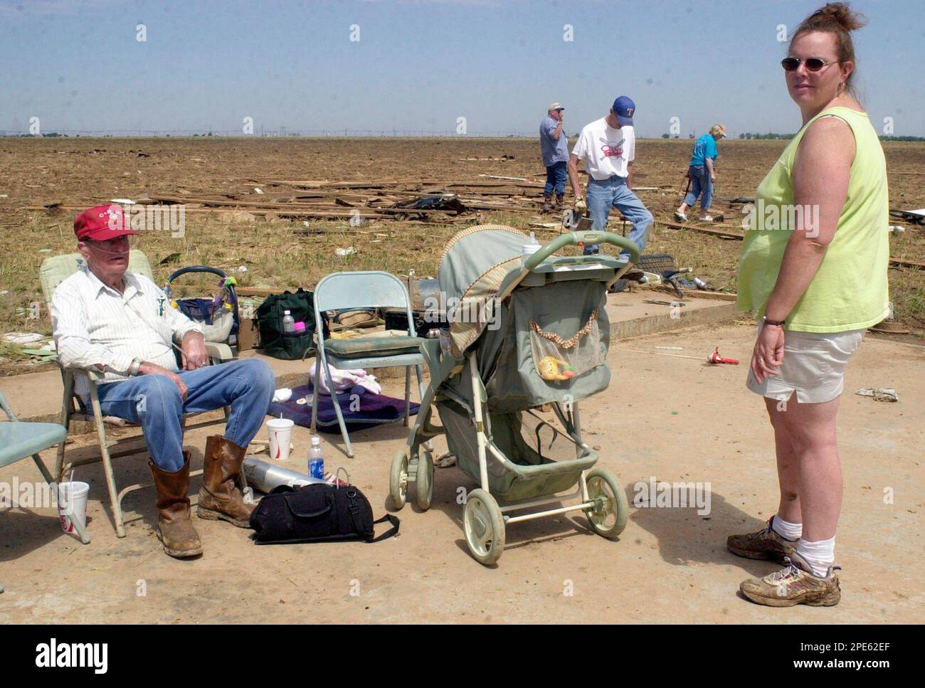 Harley Reese, left, sits among the few salvageable items Friday, May 13 ...