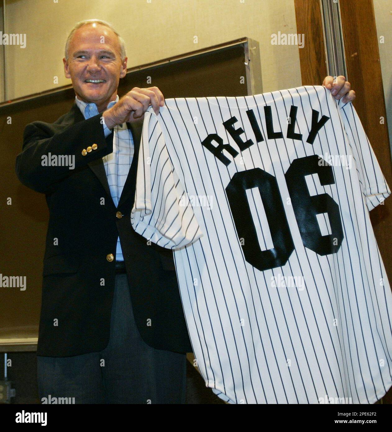 Massachusetts Attorney General Thomas Reilly holds up a jersey given to ...