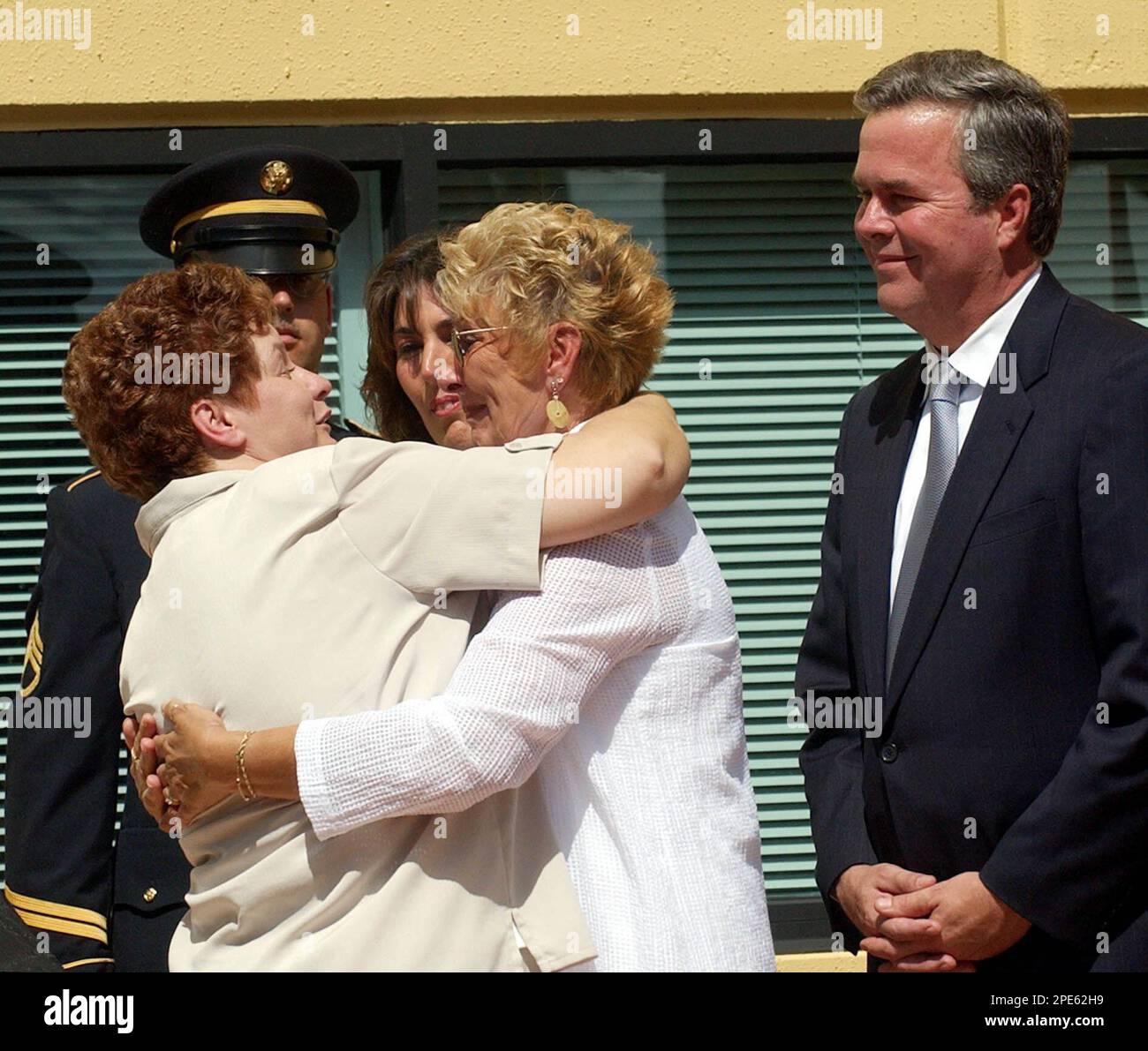Birgit Smith, the widow of Sgt.1st Class Paul Ray Smith, left, embraces ...