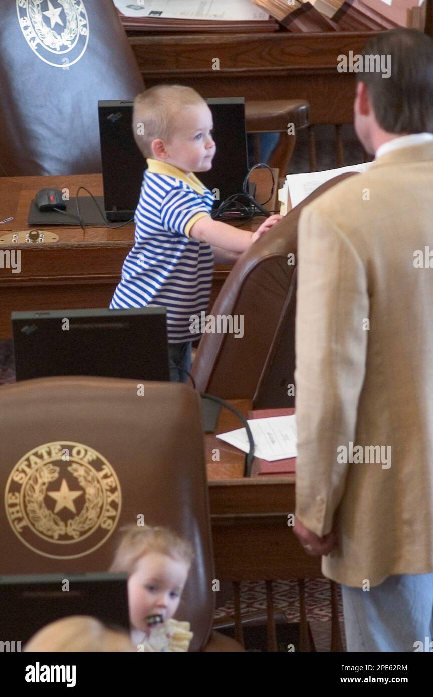 Gray Eiland, top left, looks at his father, Rep. Craig Eiland, D ...