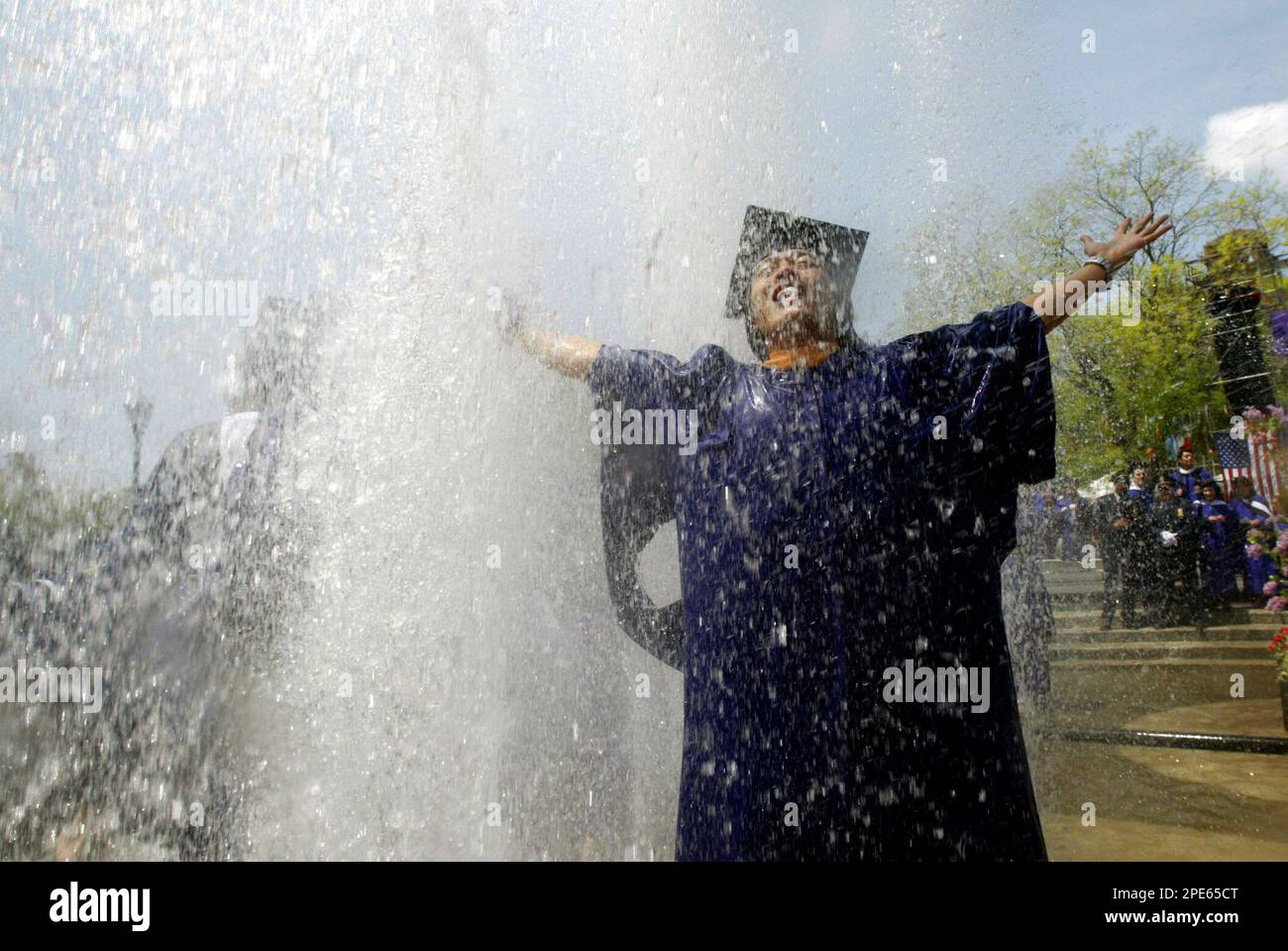 A New York University graduate celebrates by taking a plunge into ...