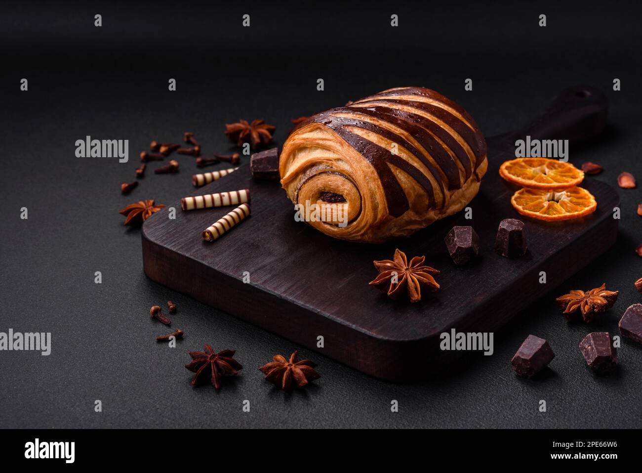 Delicious sweet crispy fresh baked cinnamon bun on dark concrete ...