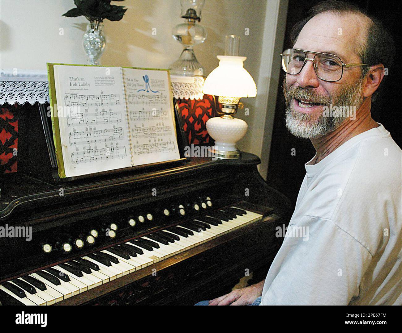 Anthony Young sits at one of the 17 organs in his collection and plays ...