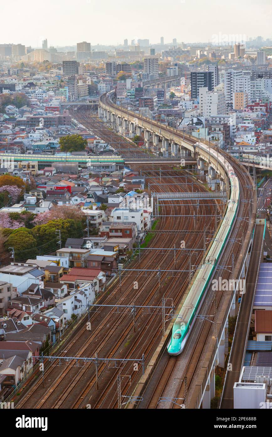A Shinkansen, the famous japanese bullet train, passes through Tokyo ...