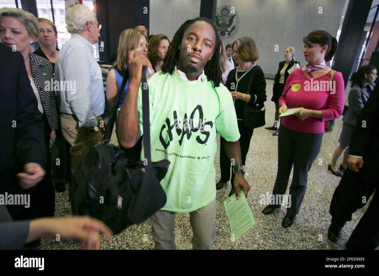 Wesley Collier, a 13-year flight attendant from New York, wears a CHAOS ...