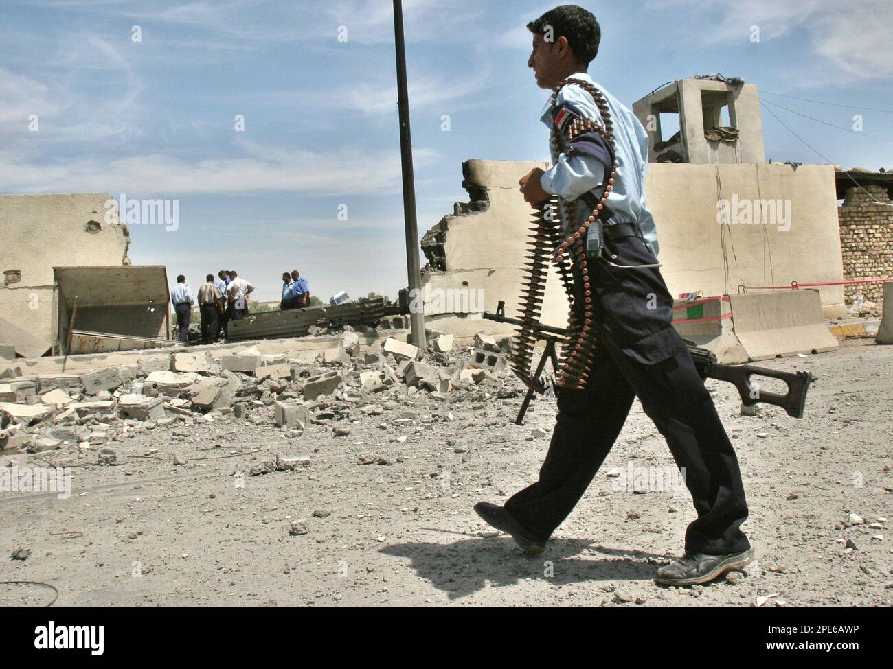 An Iraqi police man arrives after a car bomb exploded at the ...