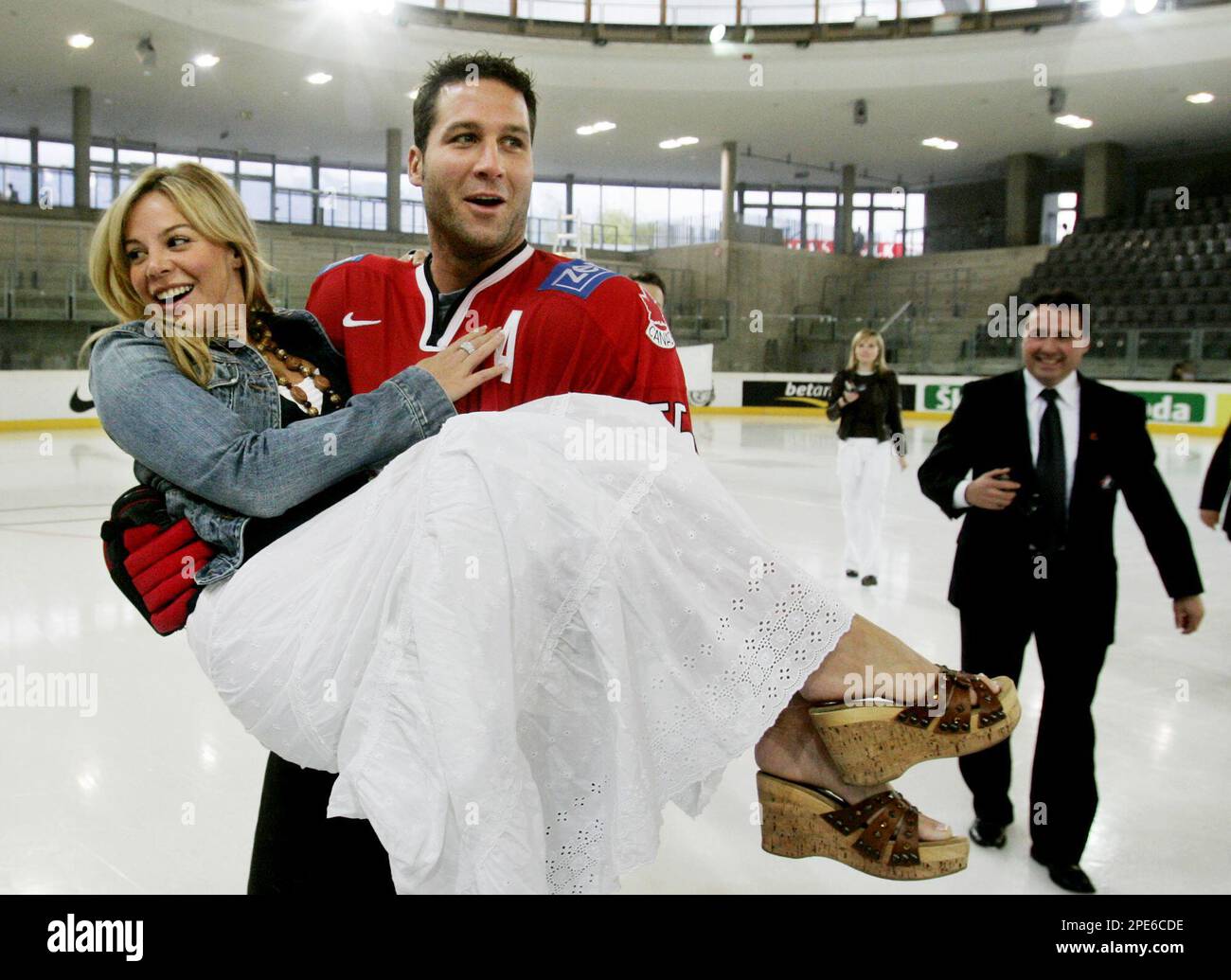 Team Canada's Ed Jovanovski carries wife Kirsten off the ice following ...