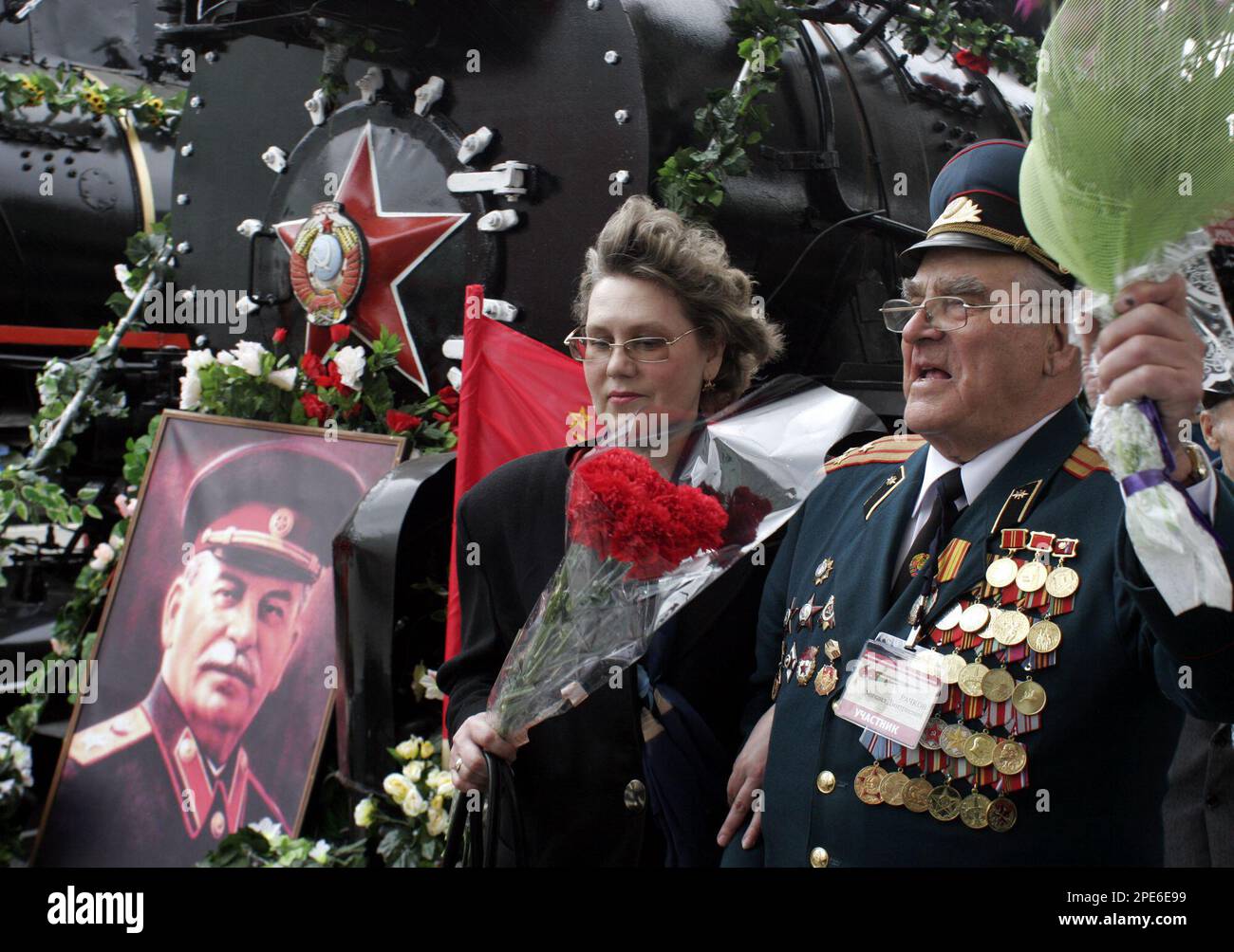 With a big portrait of smiling Soviet dictator Josef Stalin fixed in ...