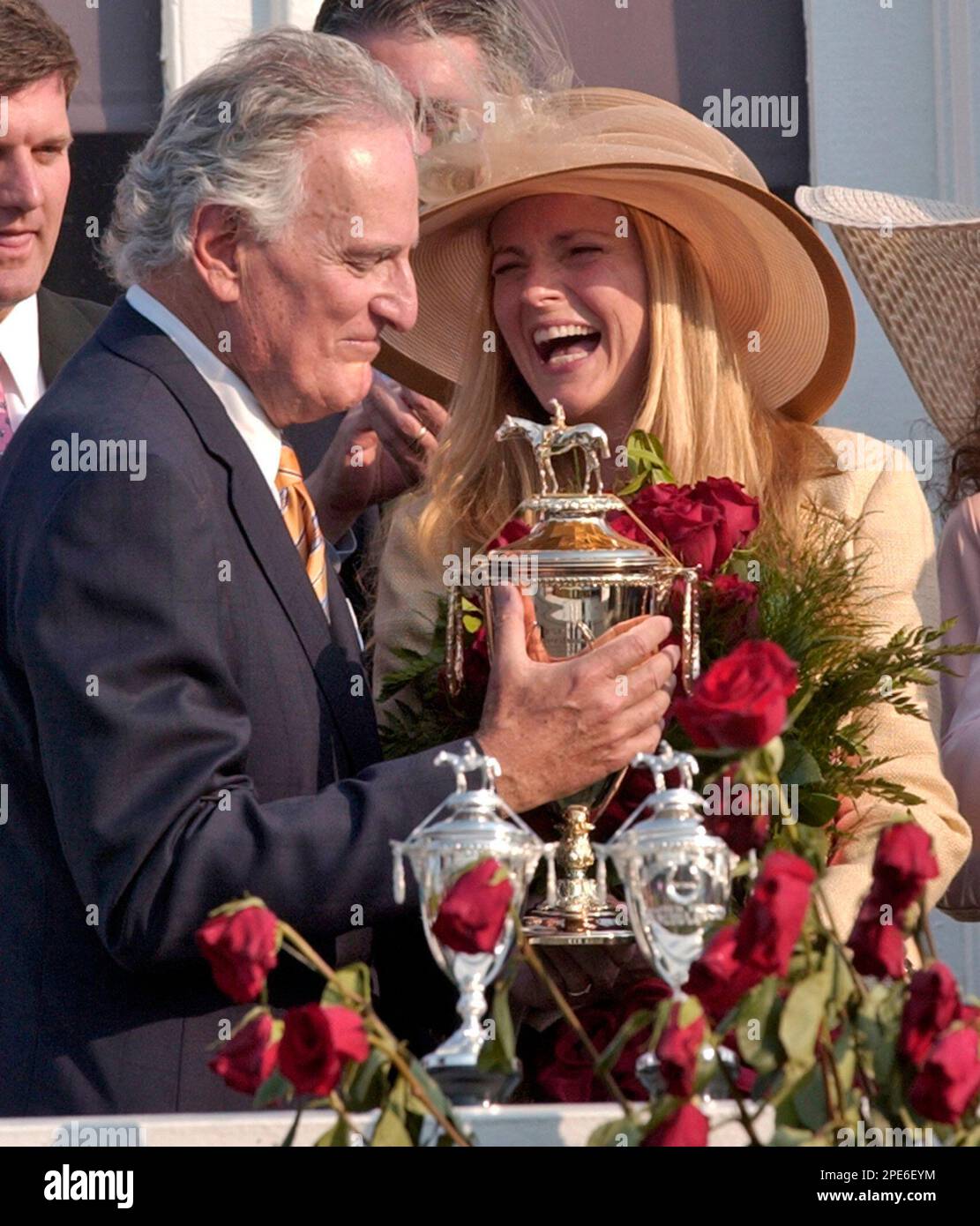 Jerome and Ann Moss celebrate with the trophy in the winner's circle ...