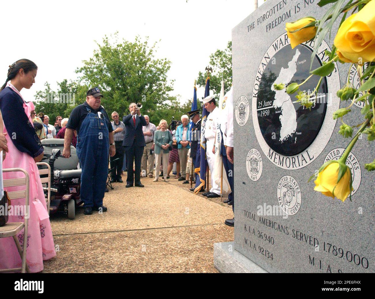 Dennis Cable, center, plays taps during unveiling ceremonies of a ...