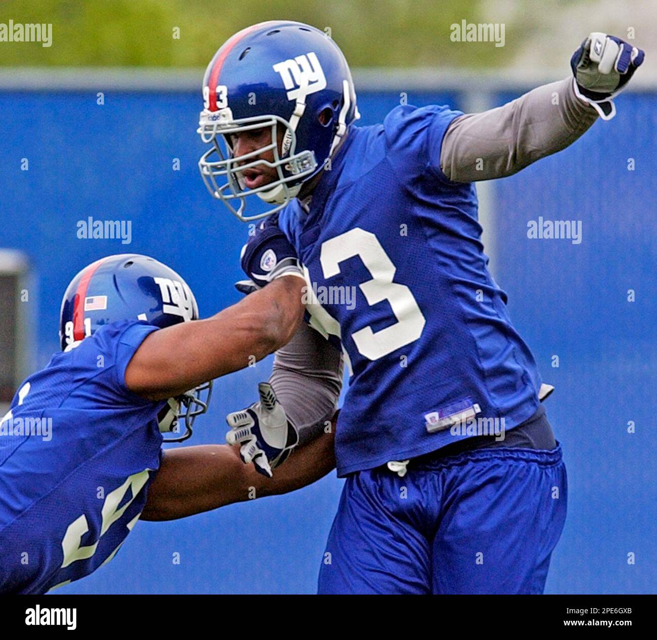 New York Giants defensive end Eric Moore, right, attempts to shed the ...