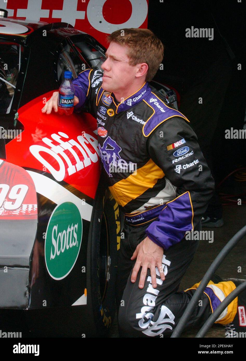 NASCAR driver Carl Edwards leans on his car during preparations for the ...