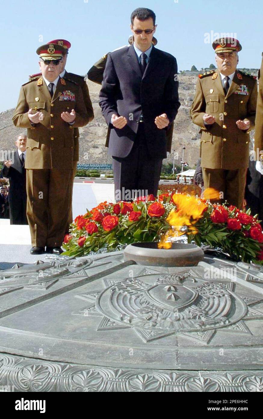 Syrian President Bashar Assad, centre, lays a wreath on the Tomb of the ...