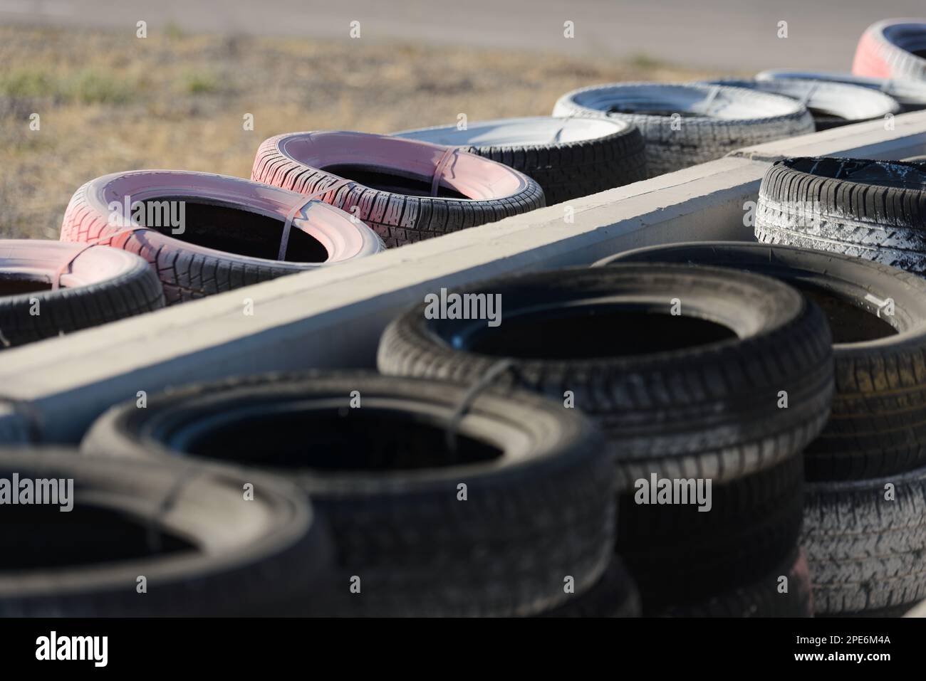 Close up shot of barrier tires in the race track Stock Photo - Alamy
