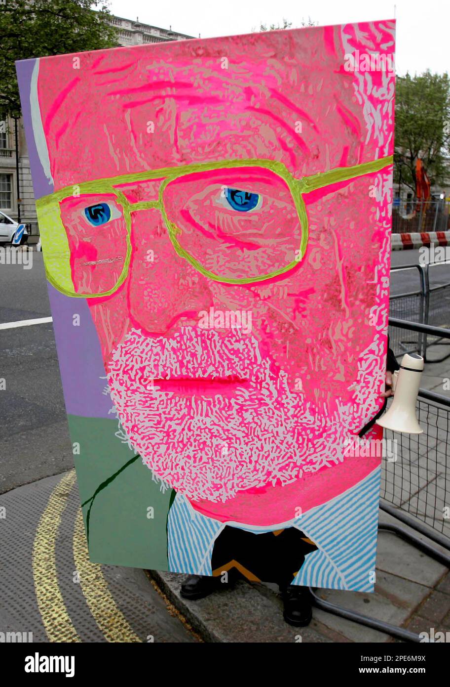 The feet of French artist Marc Molk are seen as he holds his depiction ...