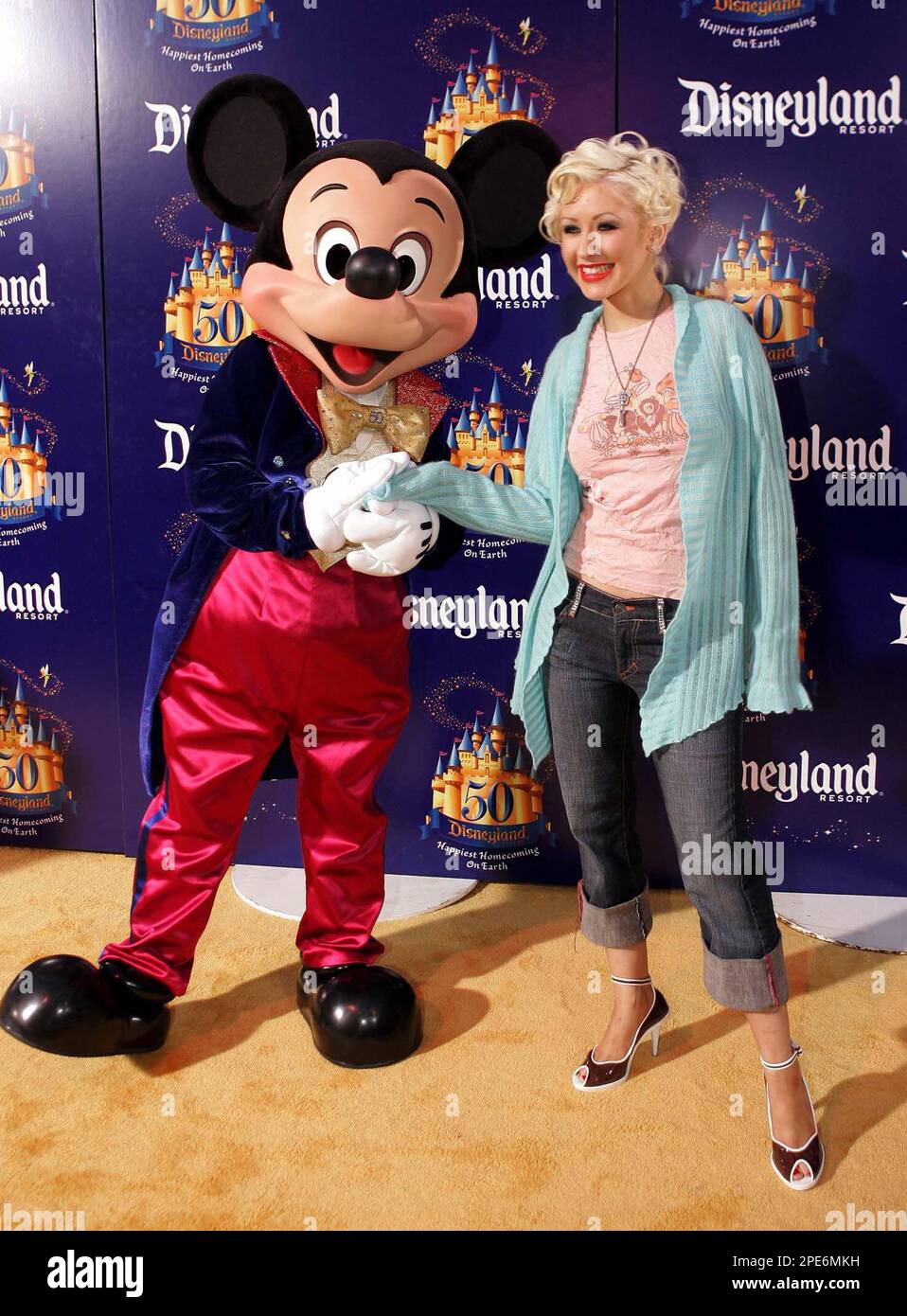 Singer Christina Aguilera greets Disney character Mickey Mouse as she ...
