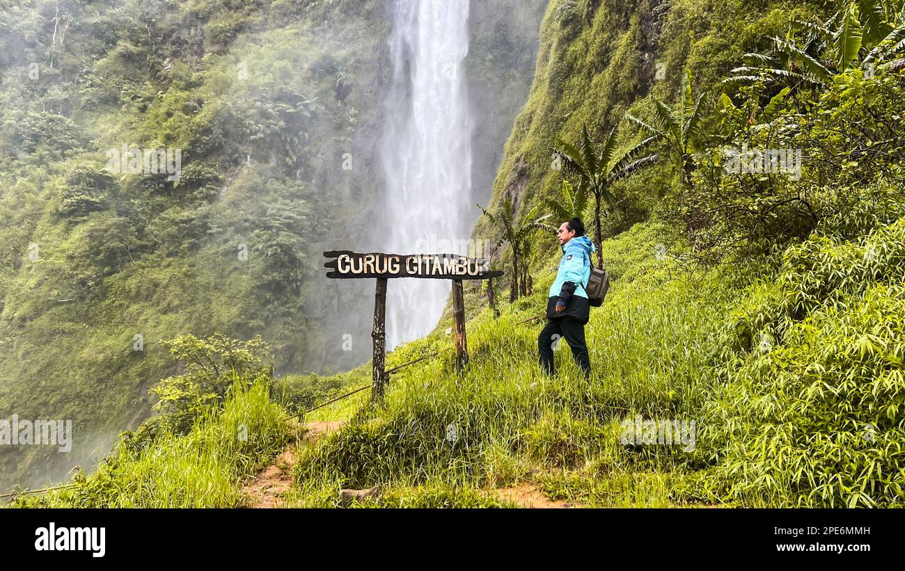 Citambur waterfall. Photo of brave man who proudly standing in front of ...